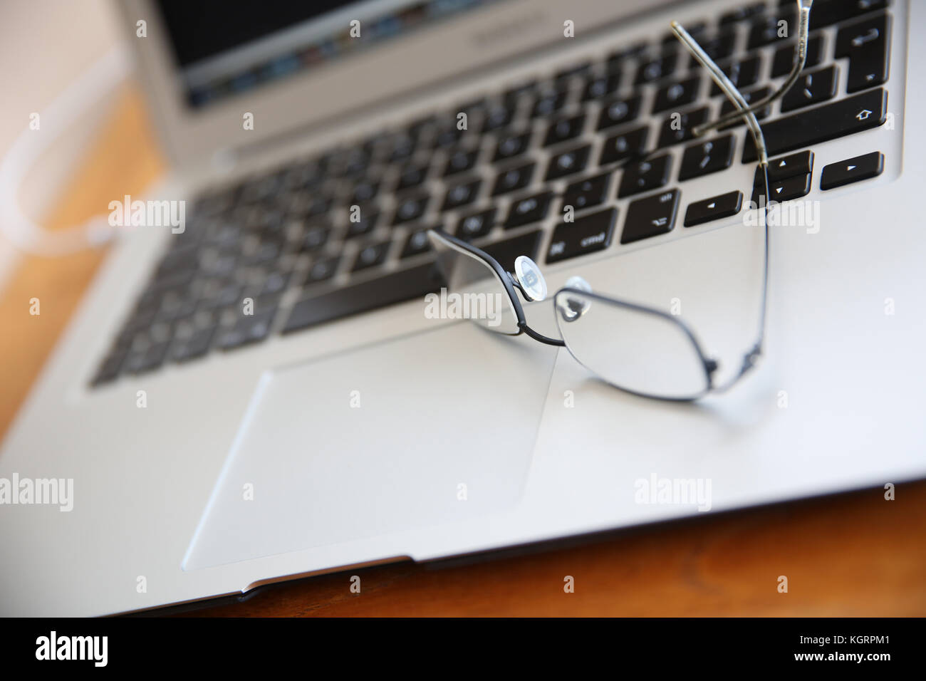 Closeup of laptop keyboard and eyeglasses Stock Photo - Alamy