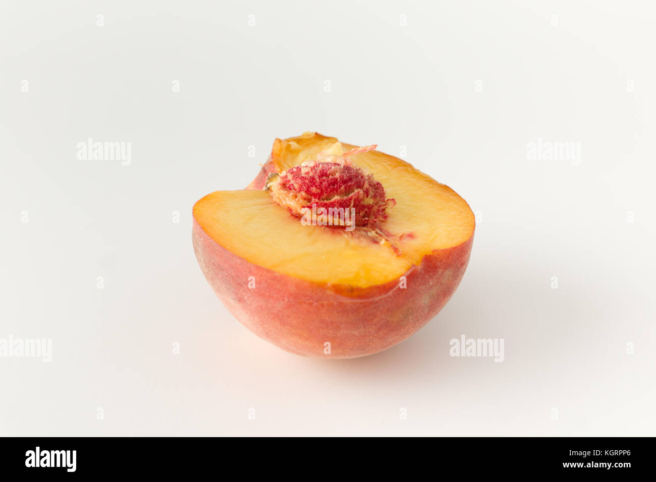 Fresh dissected peach with stone on white background Stock Photo - Alamy