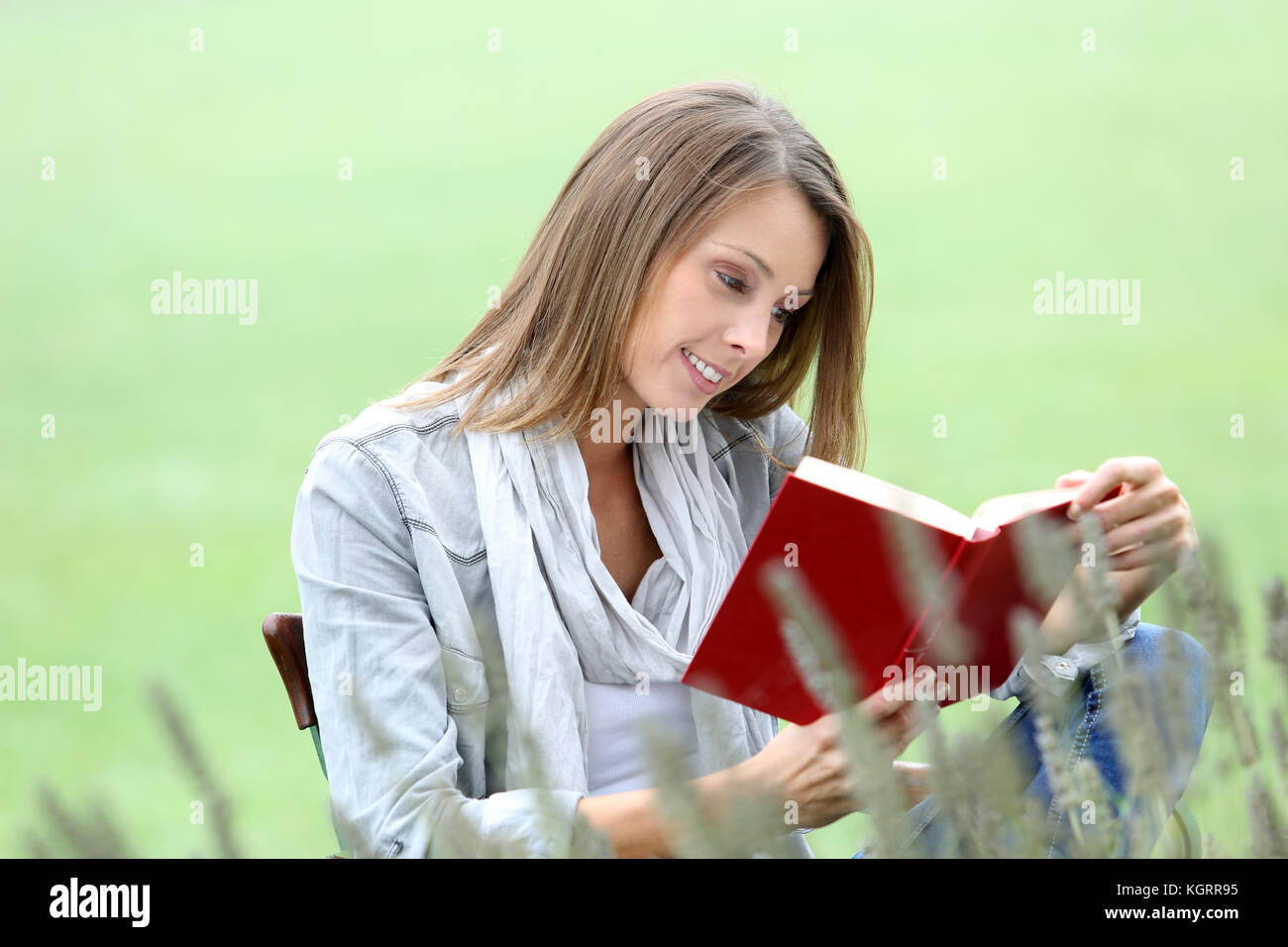 Portrait of beautiful woman reading book in nature Stock Photo - Alamy