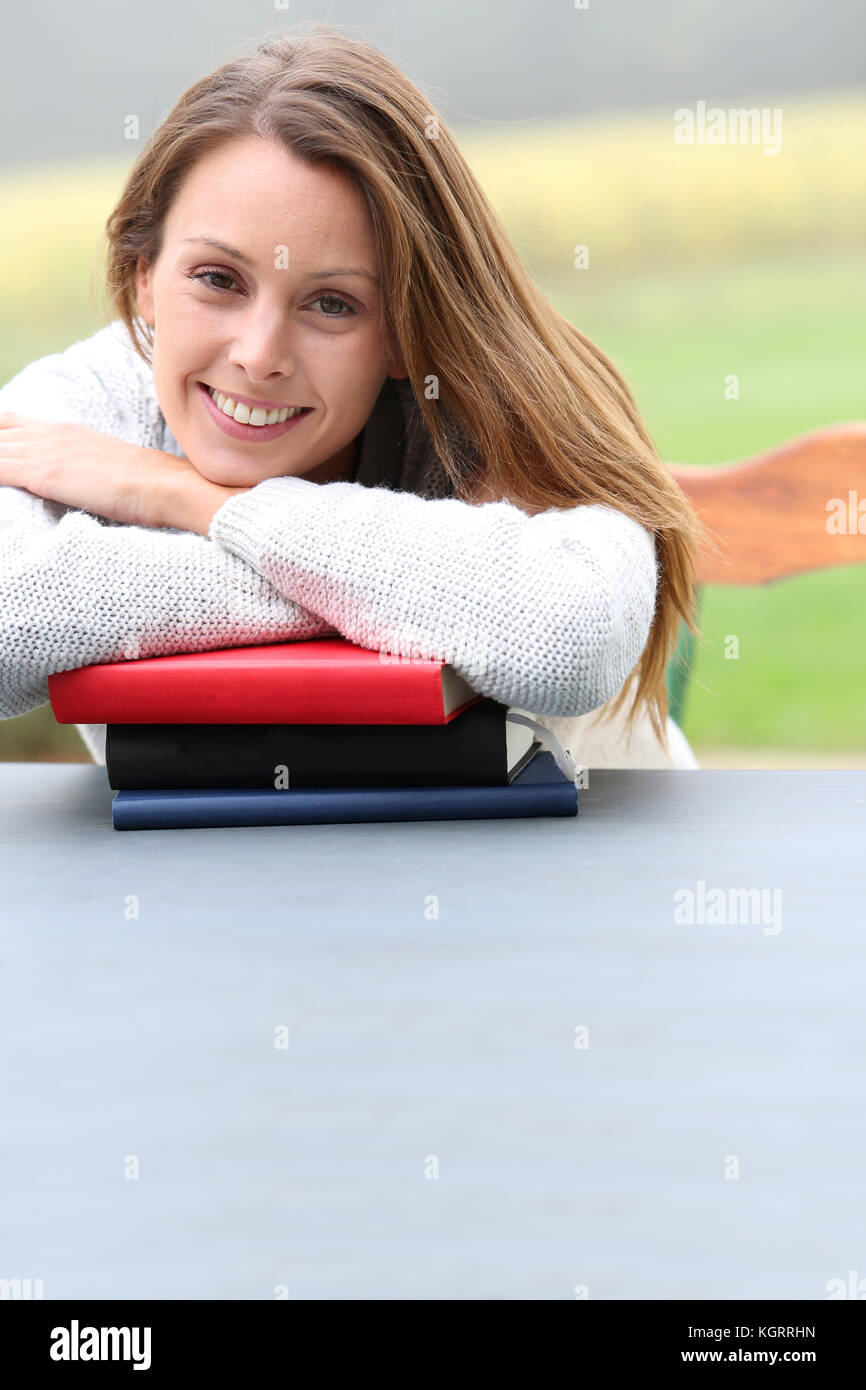 Portrait of beautiful girl leaning on books Stock Photo - Alamy