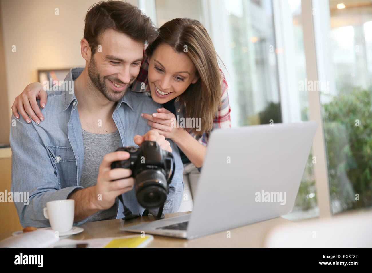 Couple watching photos on laptop computer Stock Photo - Alamy