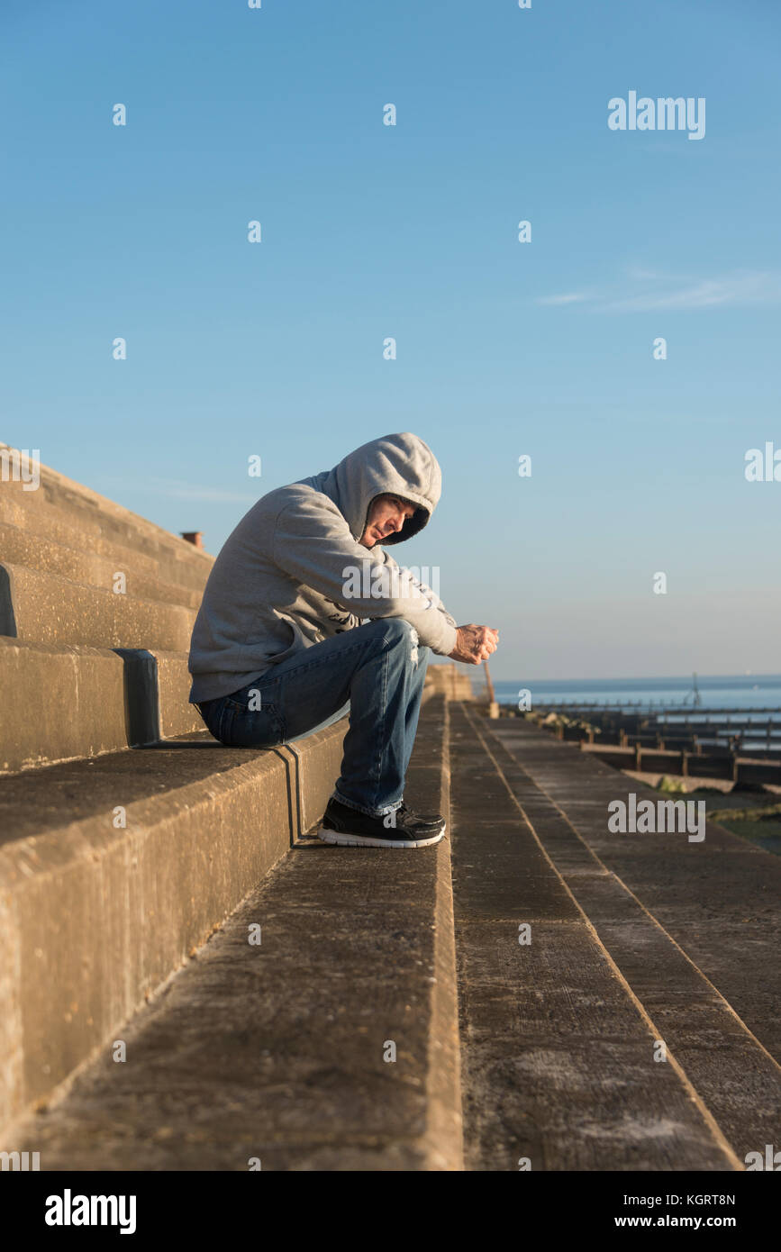 Sit alone outside hi-res stock photography and images - Alamy