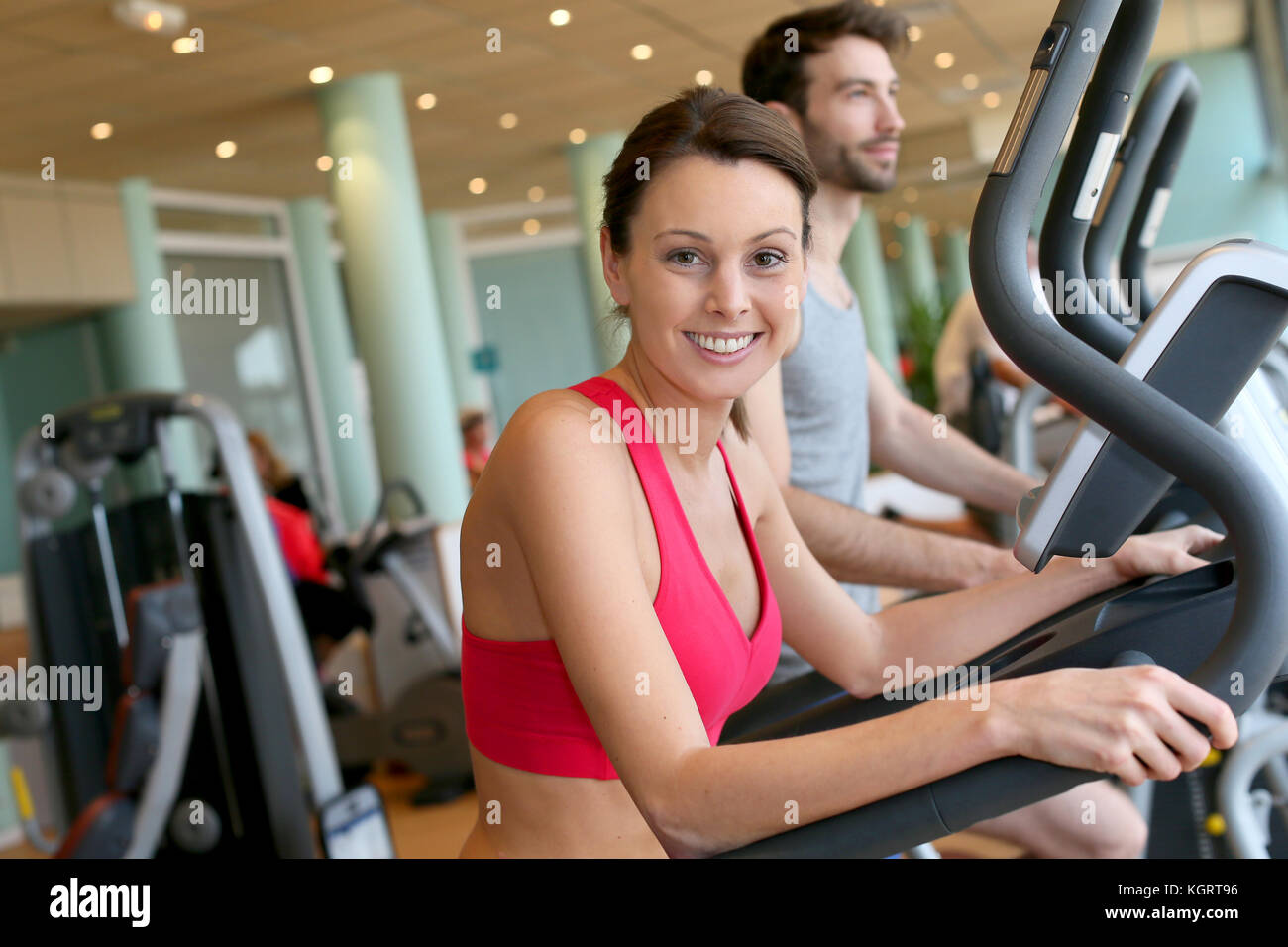 Woman in fitness club using cardio equipment Stock Photo - Alamy