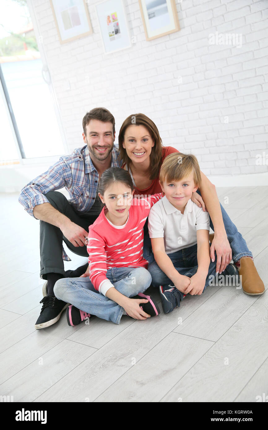 Family of four sitting on the floor Stock Photo - Alamy