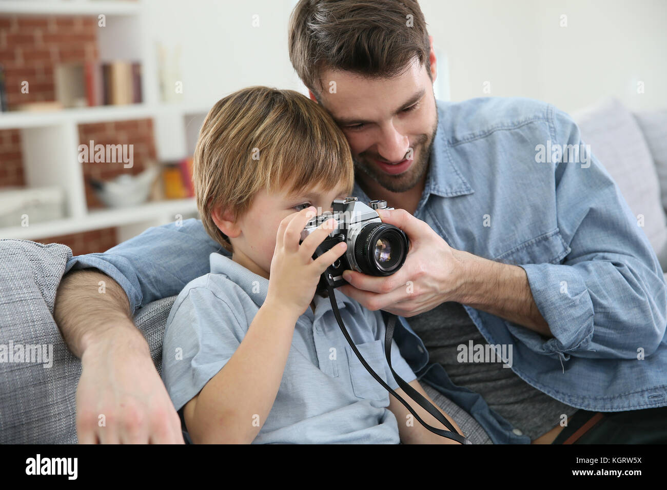 Daddy with son using photo camera Stock Photo - Alamy