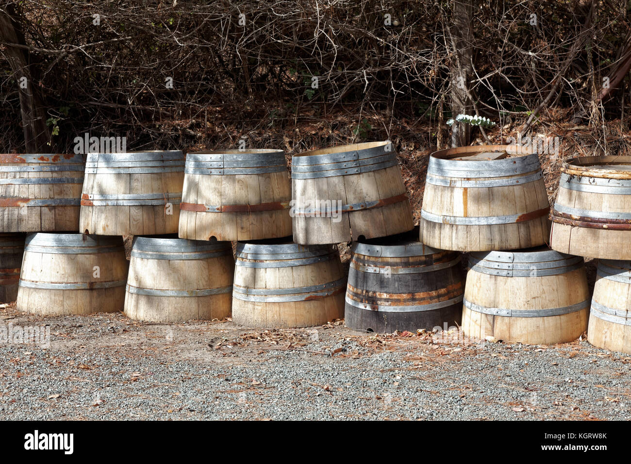 Empty wine casks selling as wood planter boxes Stock Photo - Alamy