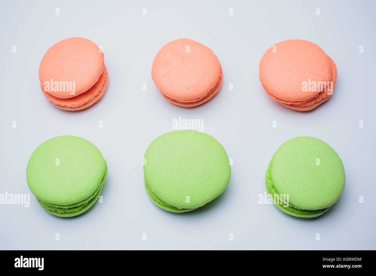 six makaruni on a colored background sweetness green Stock Photo - Alamy