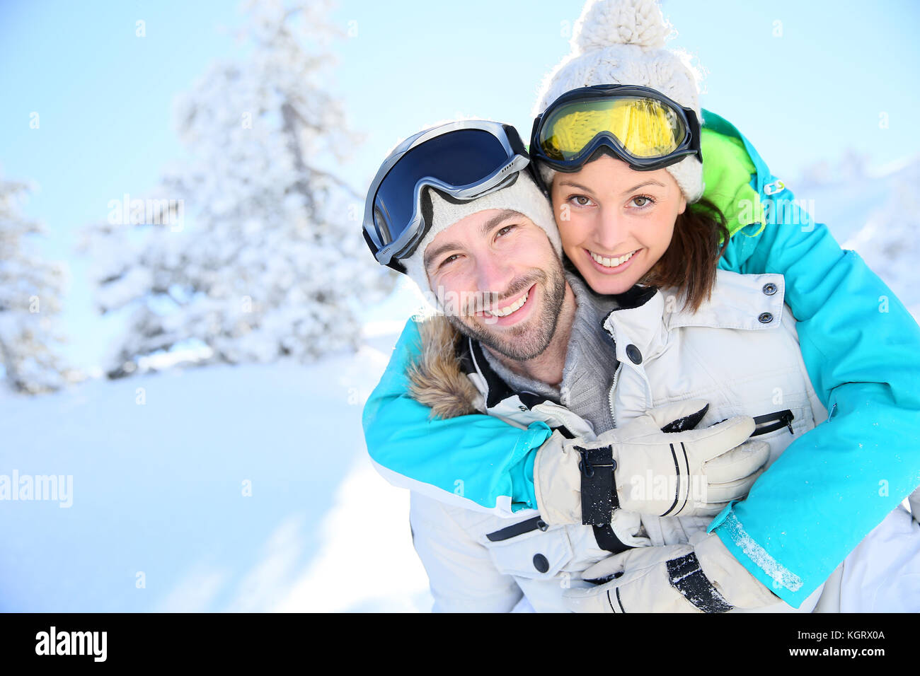 Man giving girlfriend piggyback ride in the snowy mountain Stock Photo ...