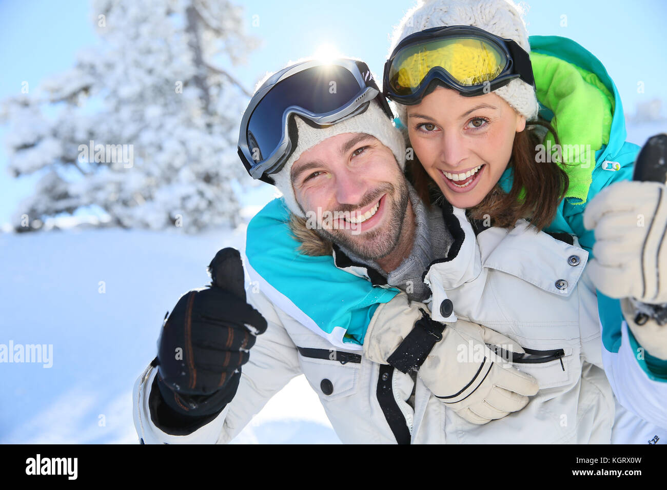 Man giving girlfriend piggyback ride in the snowy mountain Stock Photo ...