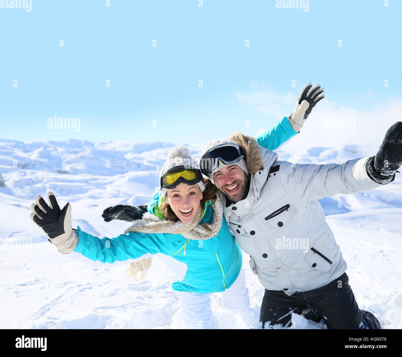 Cheerful couple of skiers having fun in the snow Stock Photo - Alamy