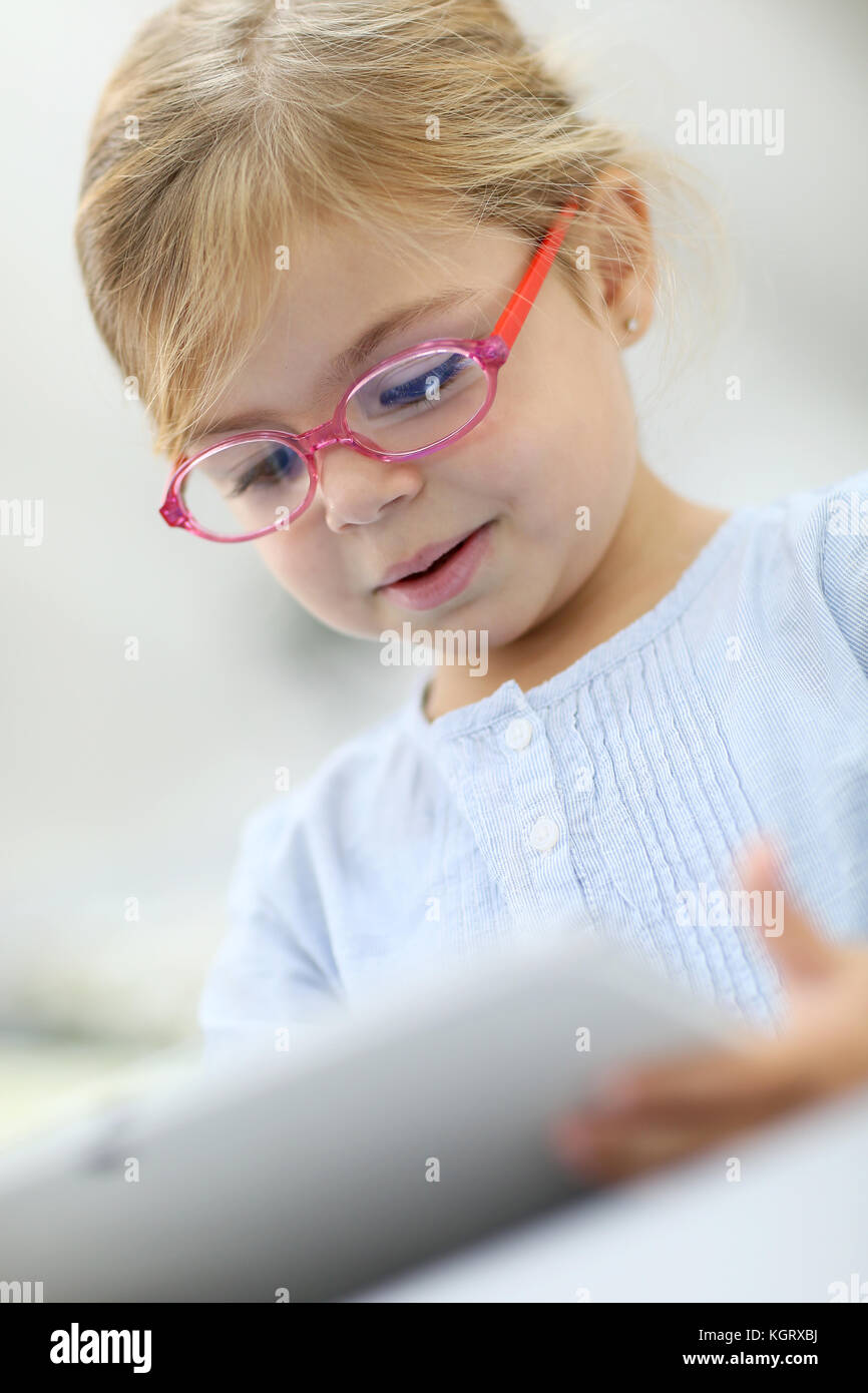 Cute little girl playing with digital tablet Stock Photo - Alamy