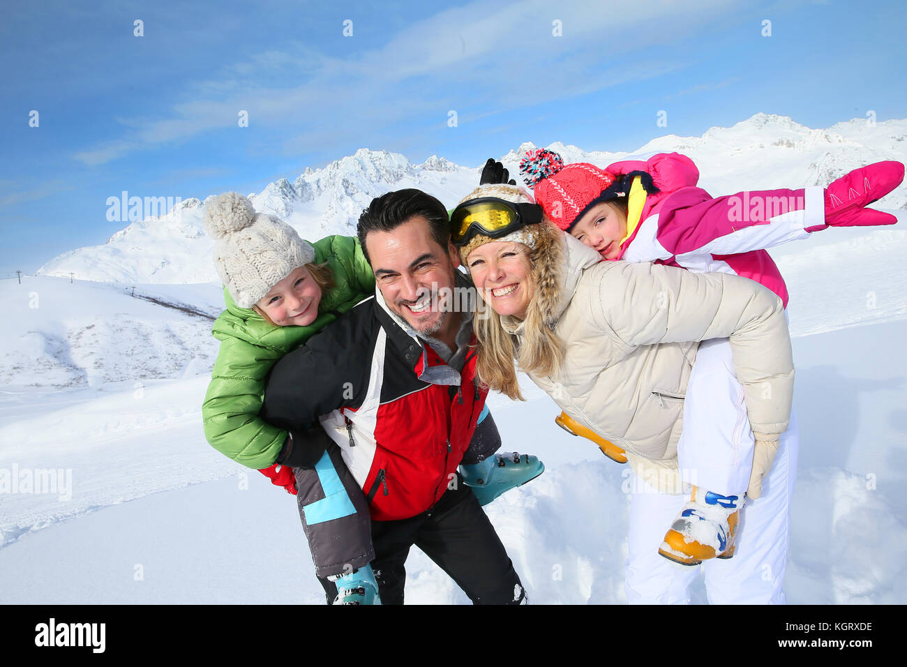 Family having fun at the top of snowy mountain Stock Photo - Alamy