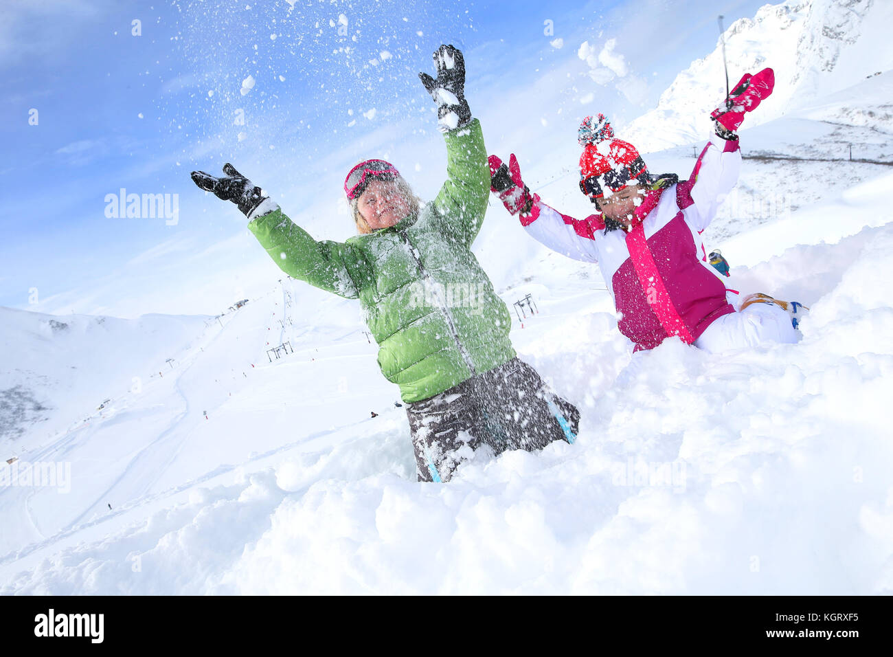 Kids having fun playing in the snow Stock Photo - Alamy
