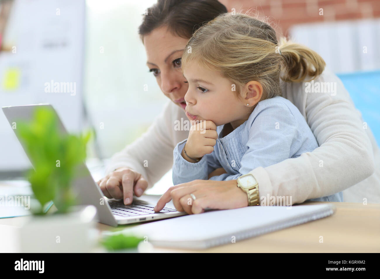 Mother working at home-office with daughter on her lap Stock Photo - Alamy