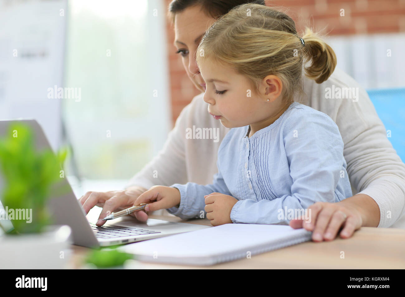 Mother working at home-office with daughter on her lap Stock Photo - Alamy