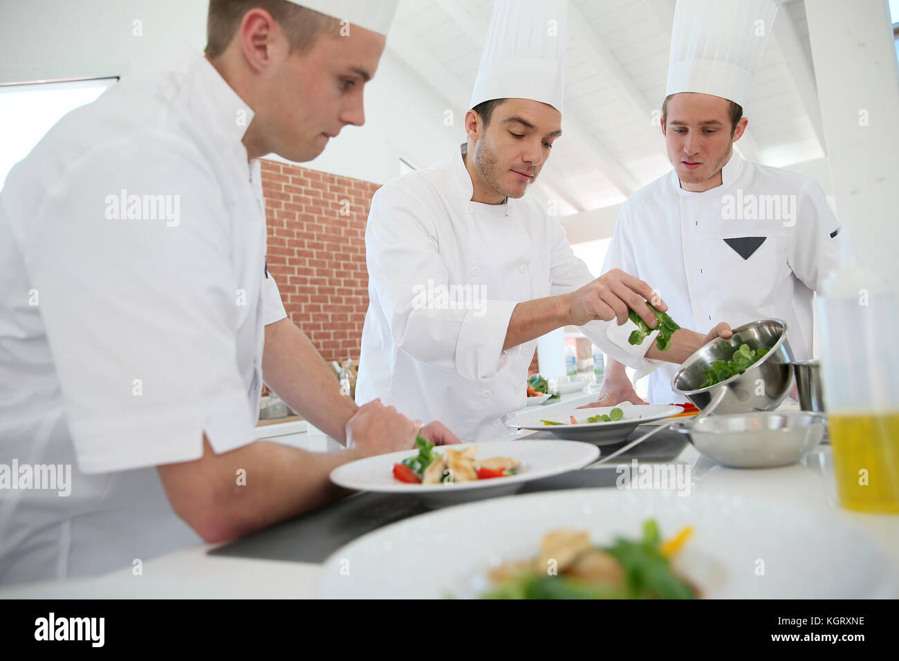 Chef training students in restaurant kitchen Stock Photo - Alamy