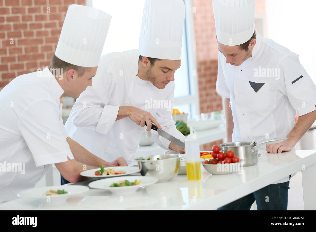 Chef training students in restaurant kitchen Stock Photo - Alamy
