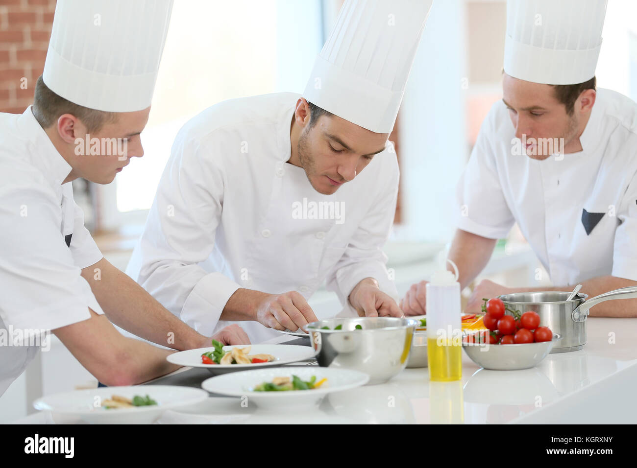 Chef training students in restaurant kitchen Stock Photo - Alamy
