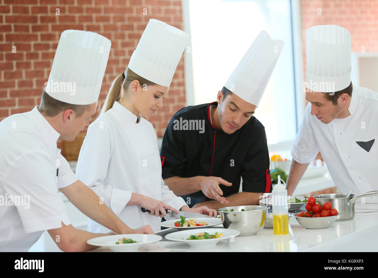 Chef training students in restaurant kitchen Stock Photo - Alamy