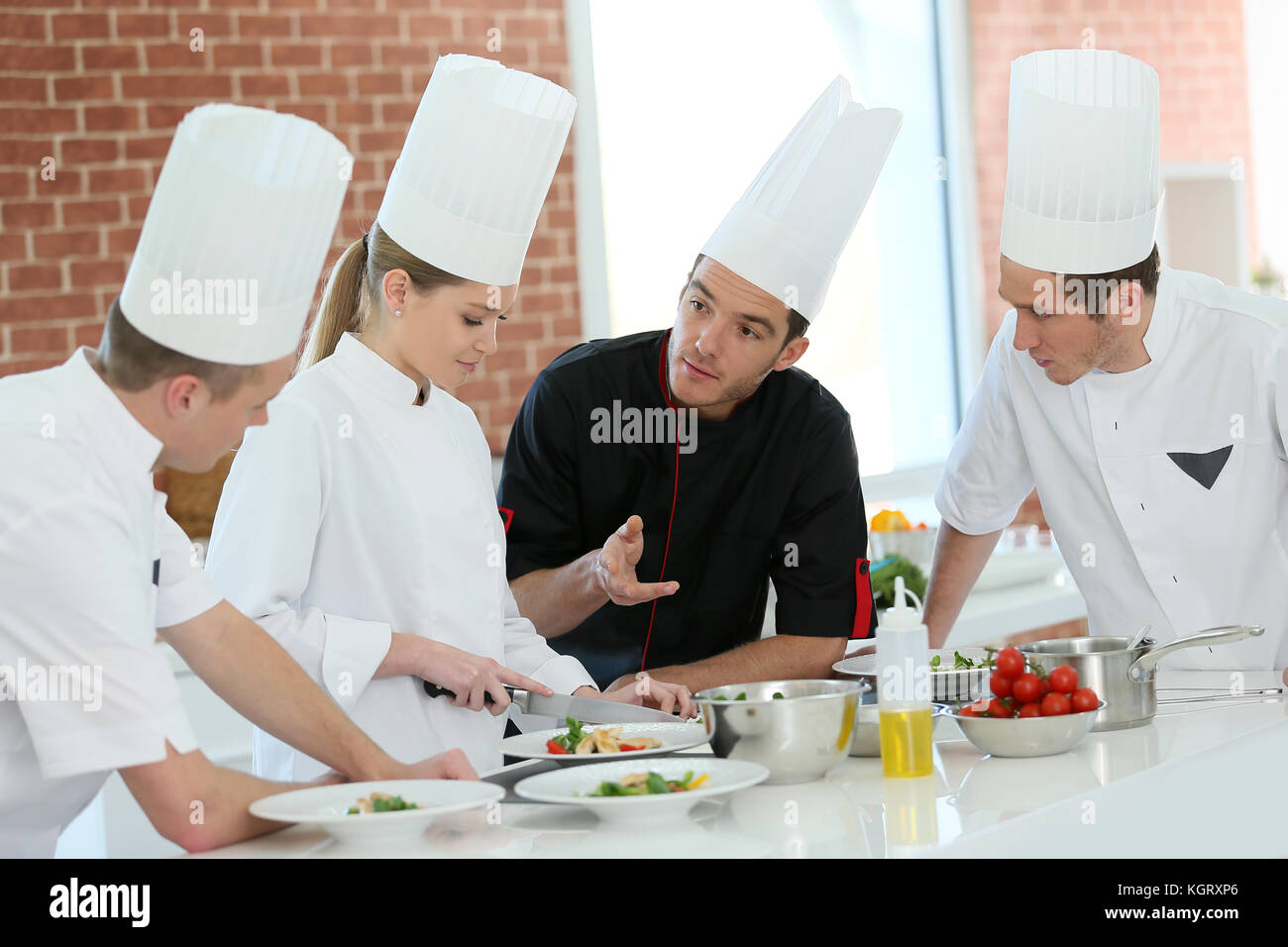 Chef training students in restaurant kitchen Stock Photo - Alamy