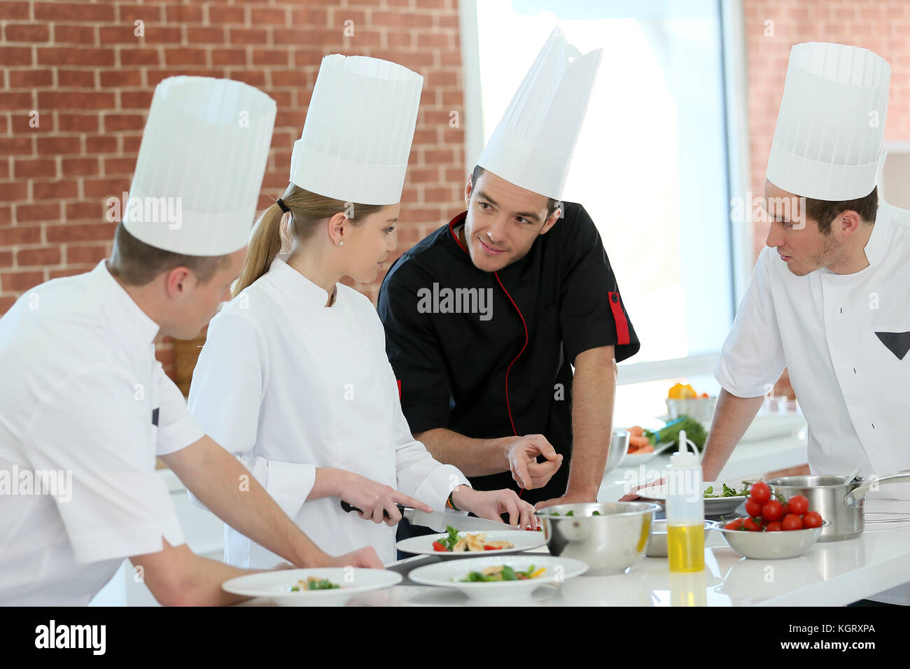 Chef training students in restaurant kitchen Stock Photo - Alamy