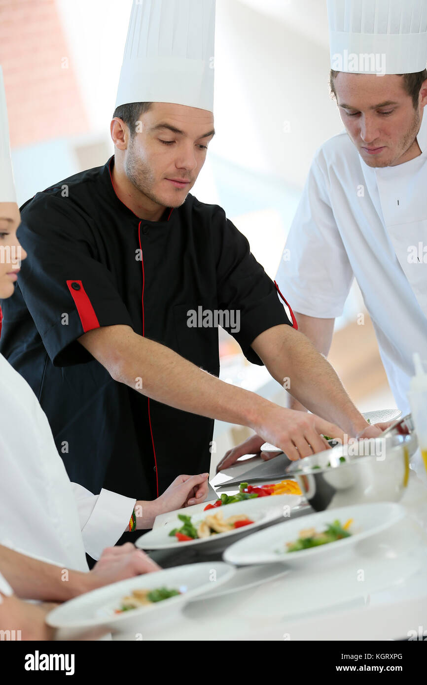 Chef training students in restaurant kitchen Stock Photo - Alamy