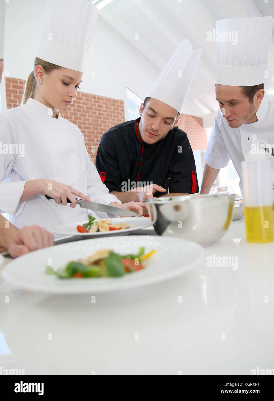 Chef training students in restaurant kitchen Stock Photo - Alamy