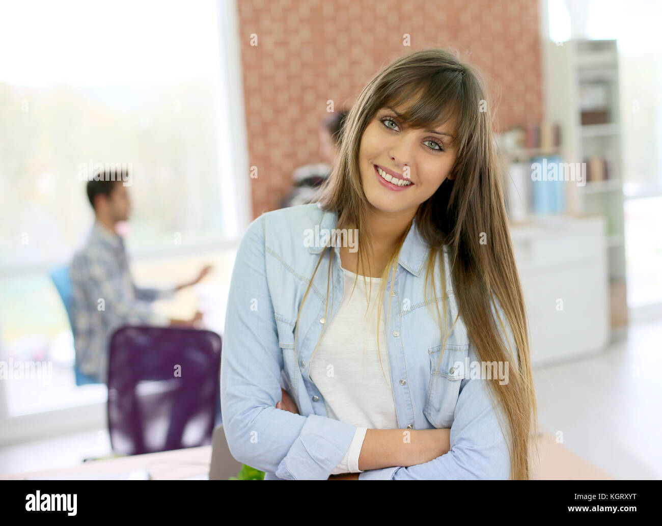 Student girl with long hair looking at camera Stock Photo - Alamy