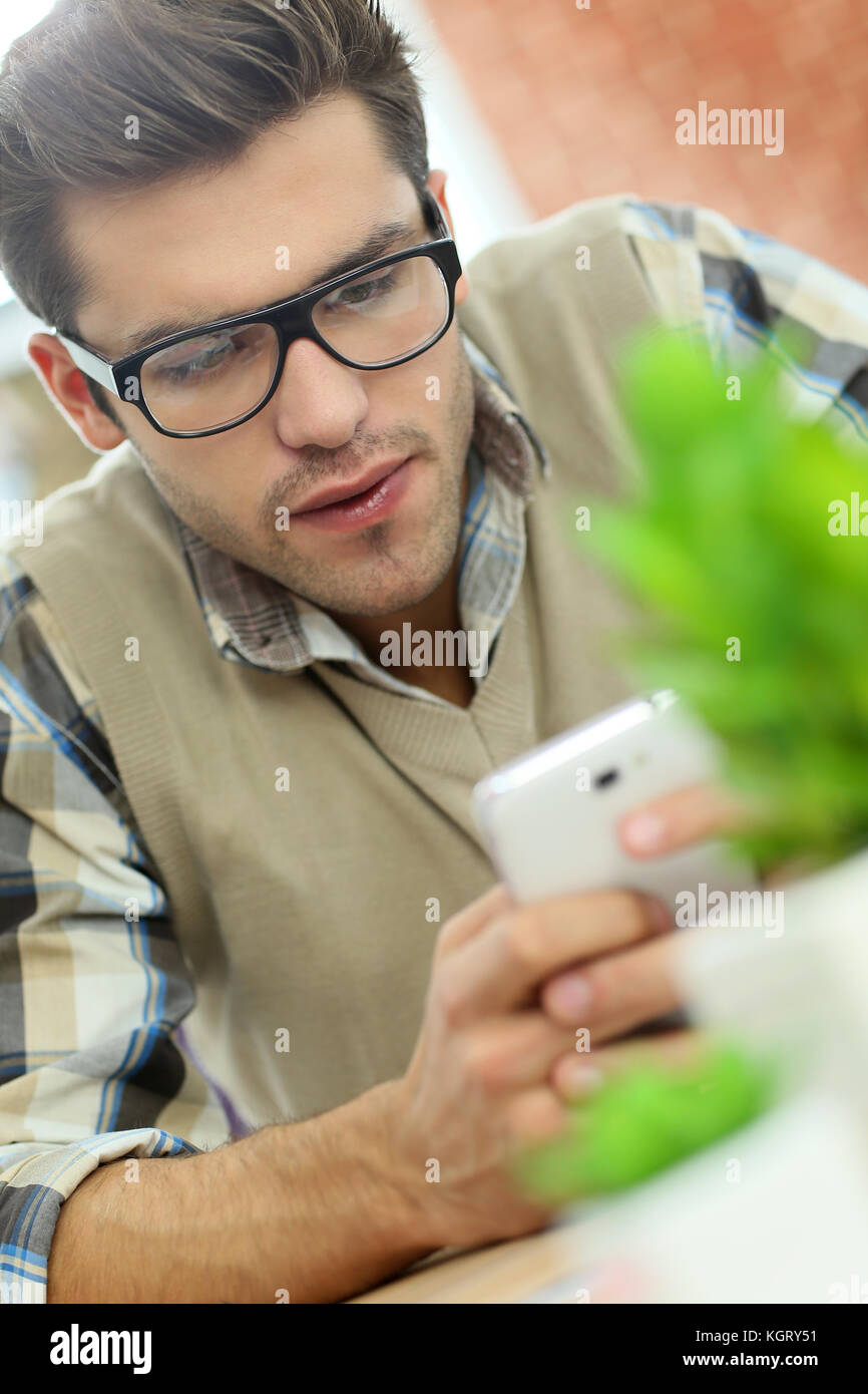 Young man connected on internet with smartphone Stock Photo - Alamy