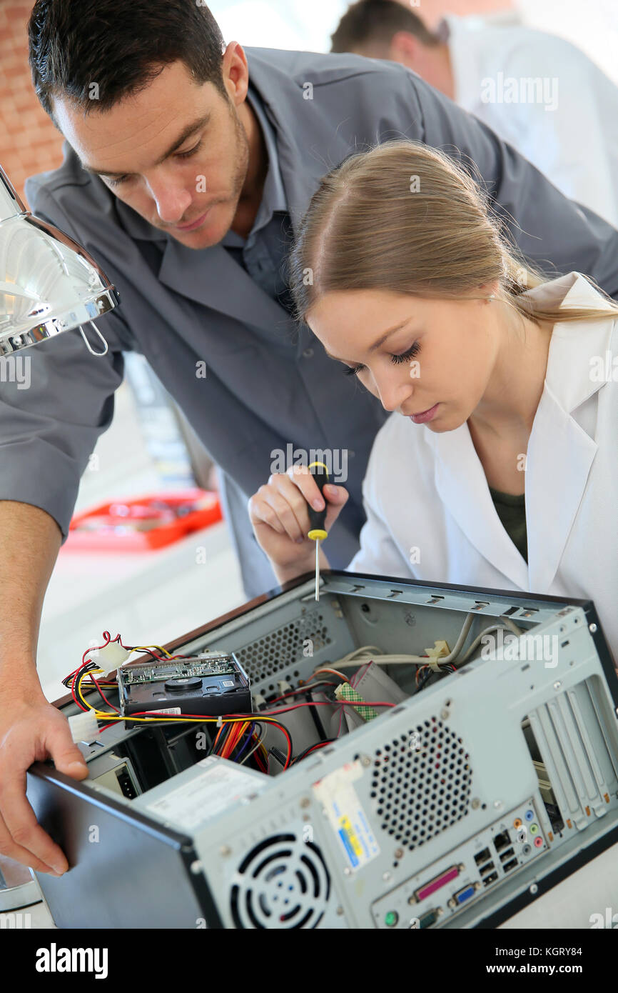 Teacher with student in technology repairing computer Stock Photo - Alamy