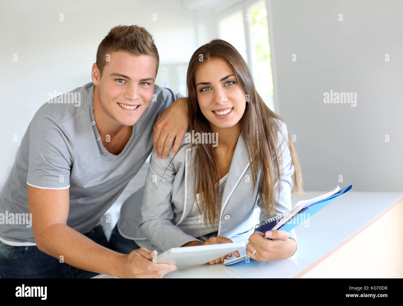 Portrait of cheerful students connected on digital tablet Stock Photo ...
