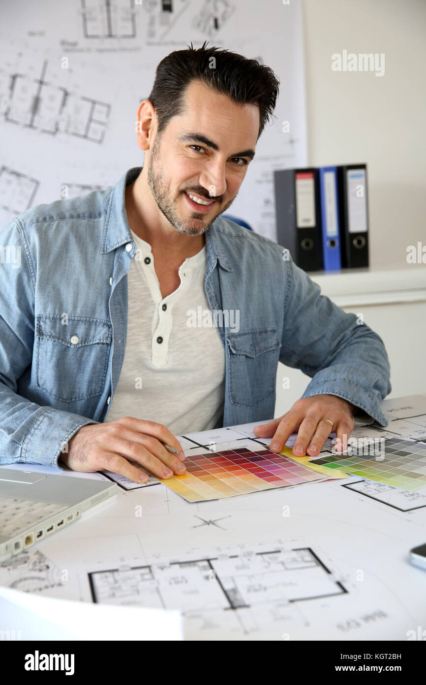 Architect working in office on blueprint Stock Photo - Alamy