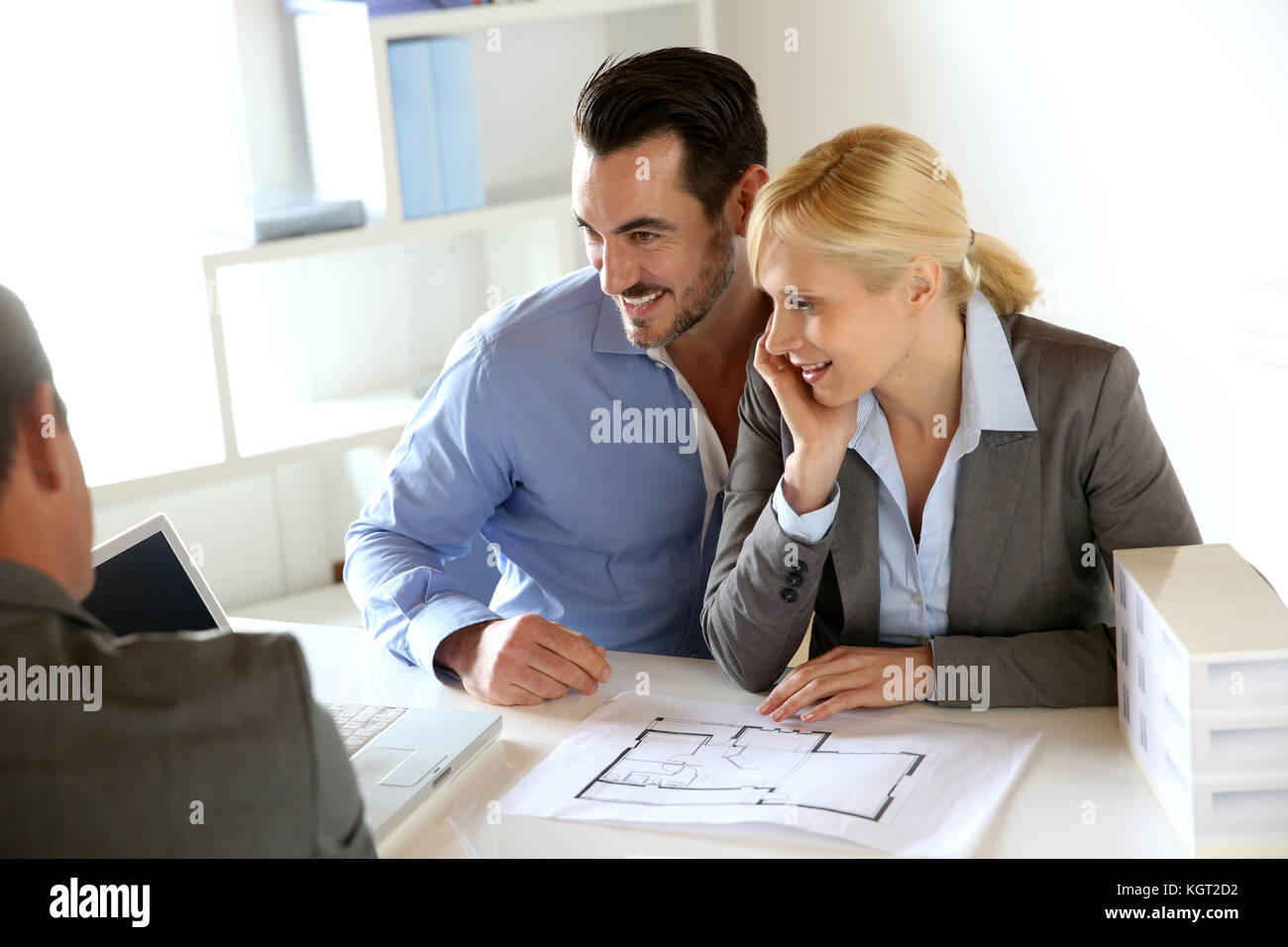 Couple meeting real-estate agent to buy property Stock Photo - Alamy