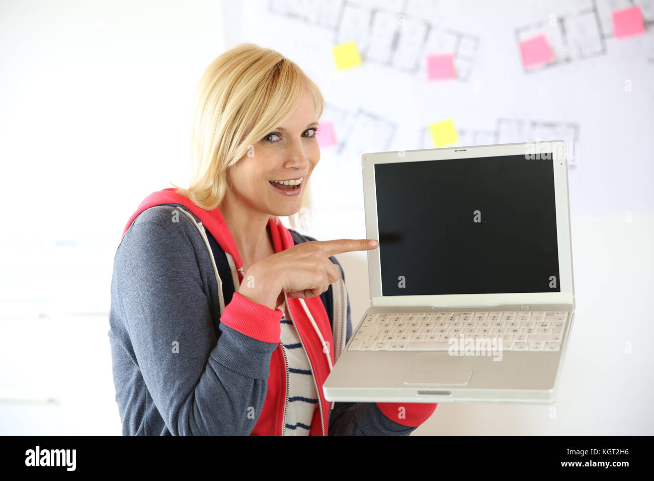 Young woman pointing at laptop screen Stock Photo - Alamy