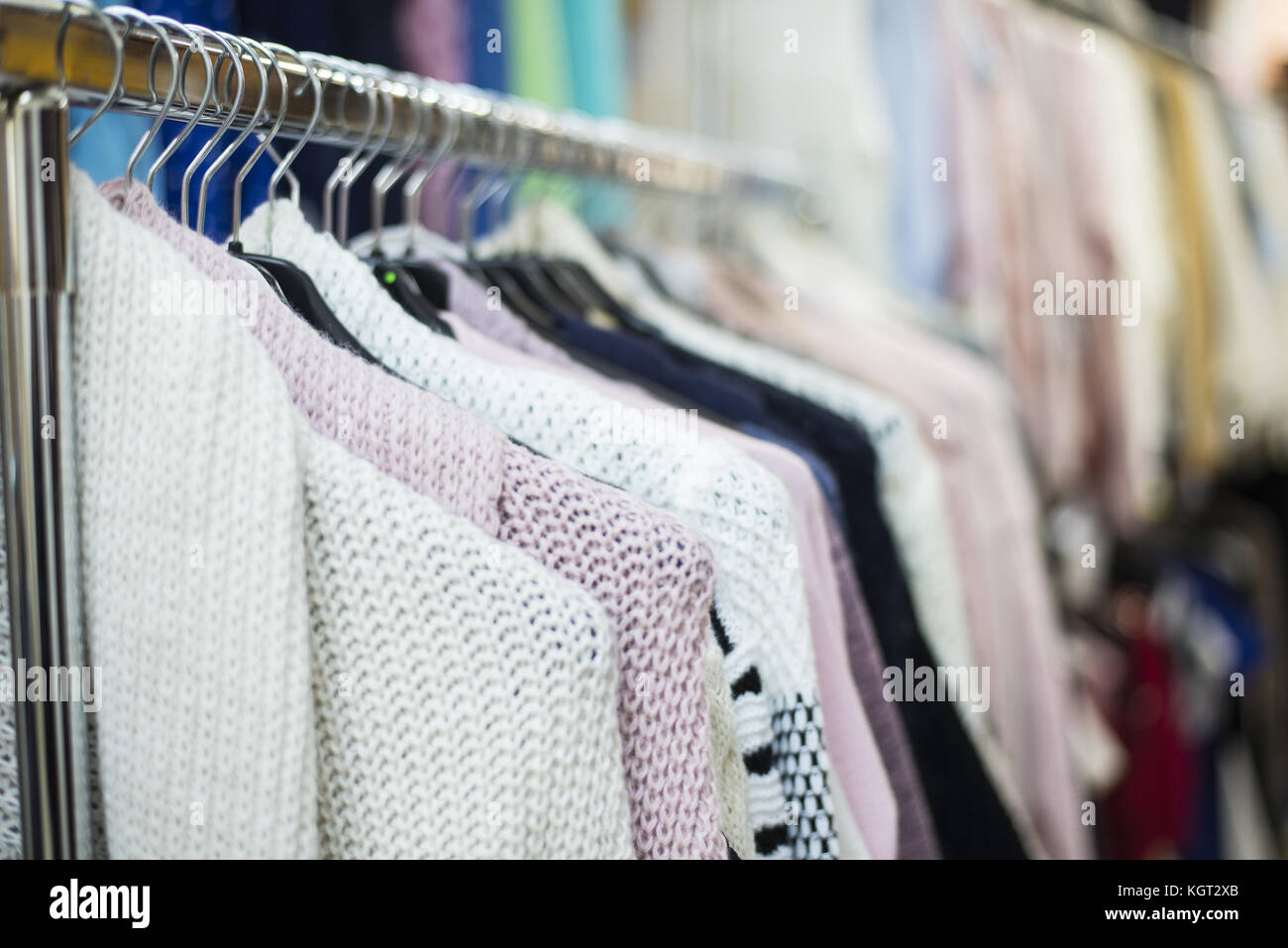 Woman clothes on hangers in textile store on sale Stock Photo - Alamy