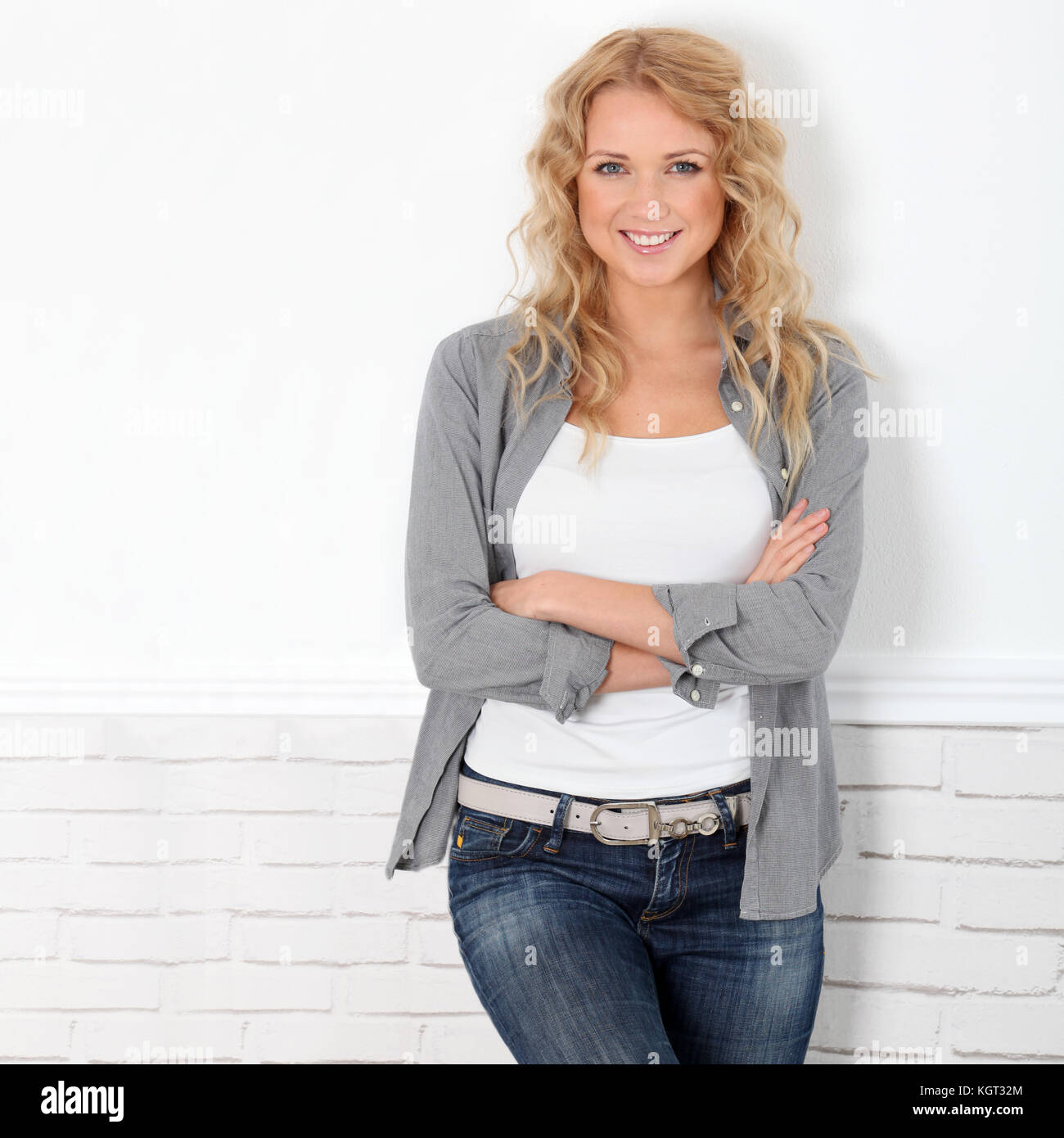 Cheerful casual woman standing on white background Stock Photo - Alamy Cheerful casual woman standing on white background Stock Photo - Alamy
