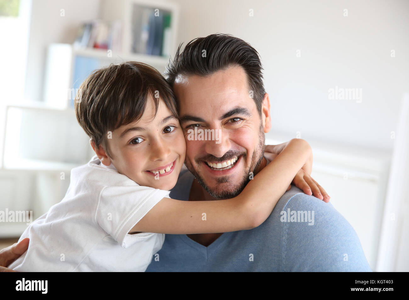 Portrait of father and son relaxing at home Stock Photo - Alamy