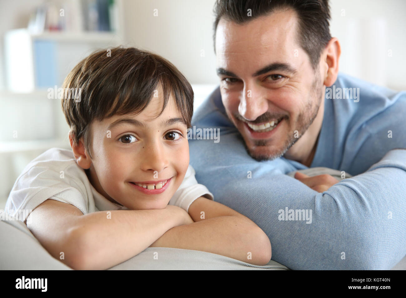 Portrait of father and son relaxing at home Stock Photo - Alamy