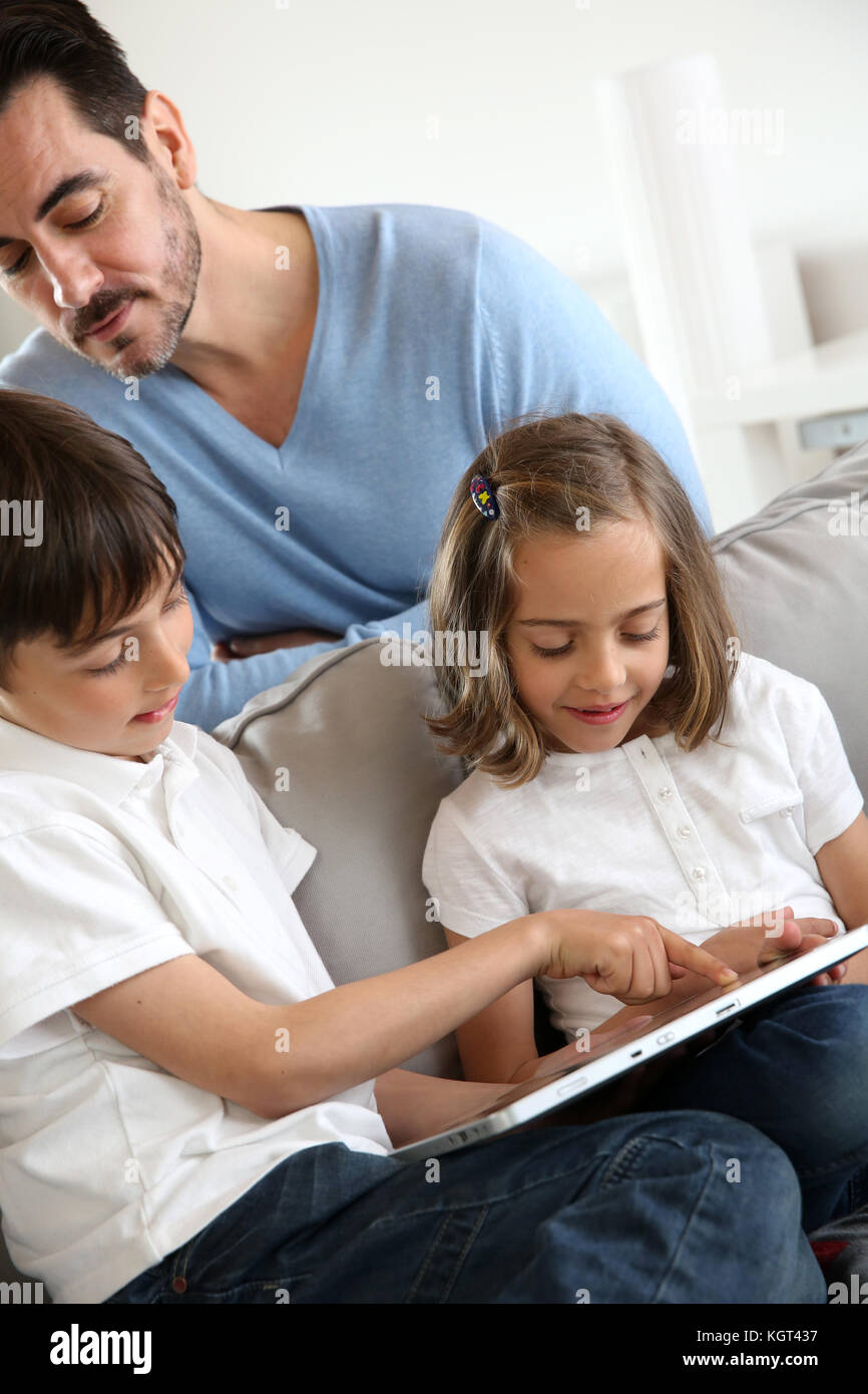 Father son using touchscreen tablet hi-res stock photography and images ...