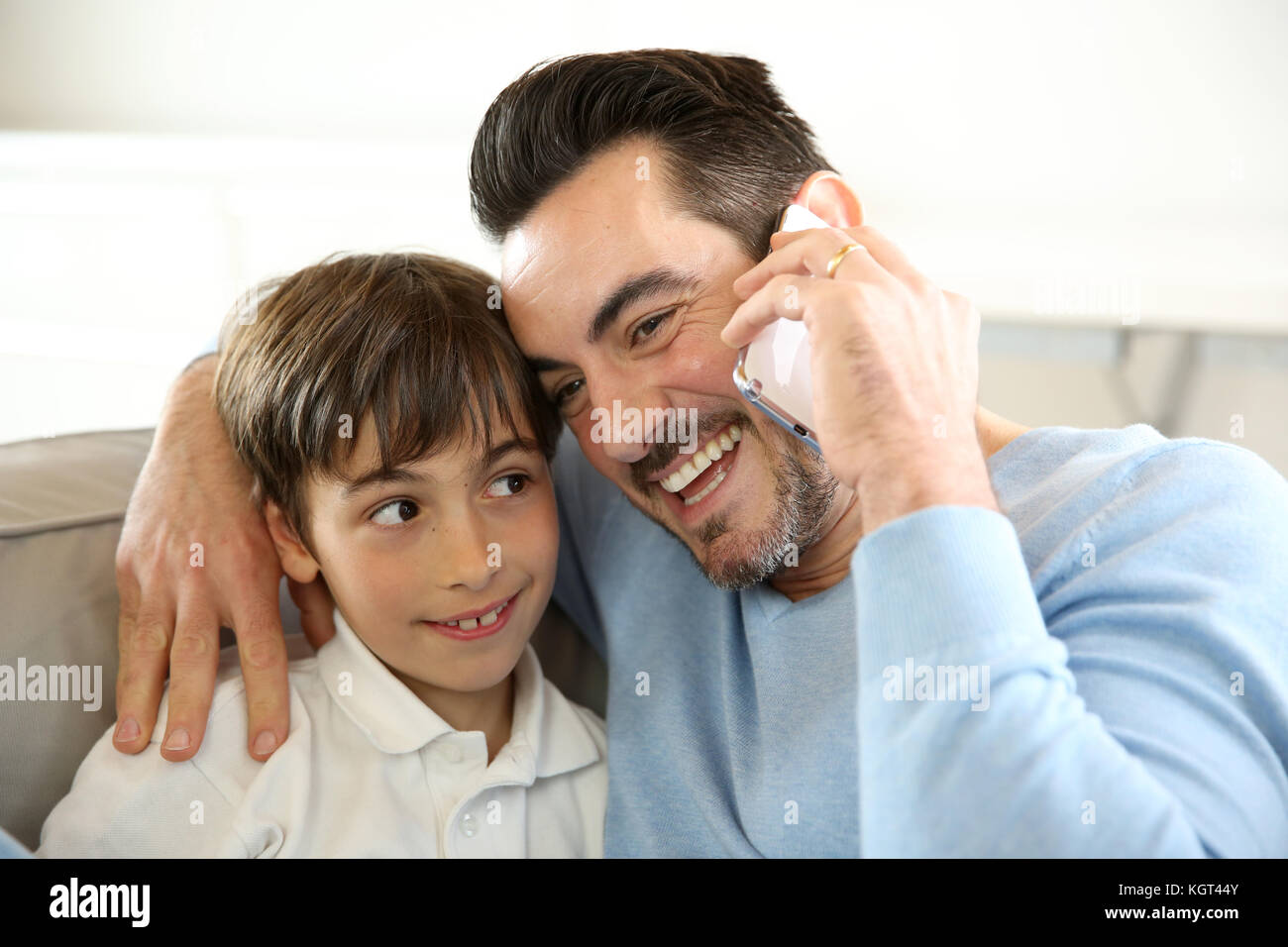 Little boy with dad playing with smartphone Stock Photo - Alamy