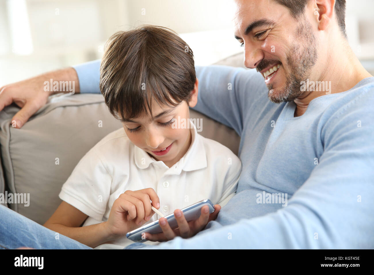 Little boy with dad playing with smartphone Stock Photo - Alamy