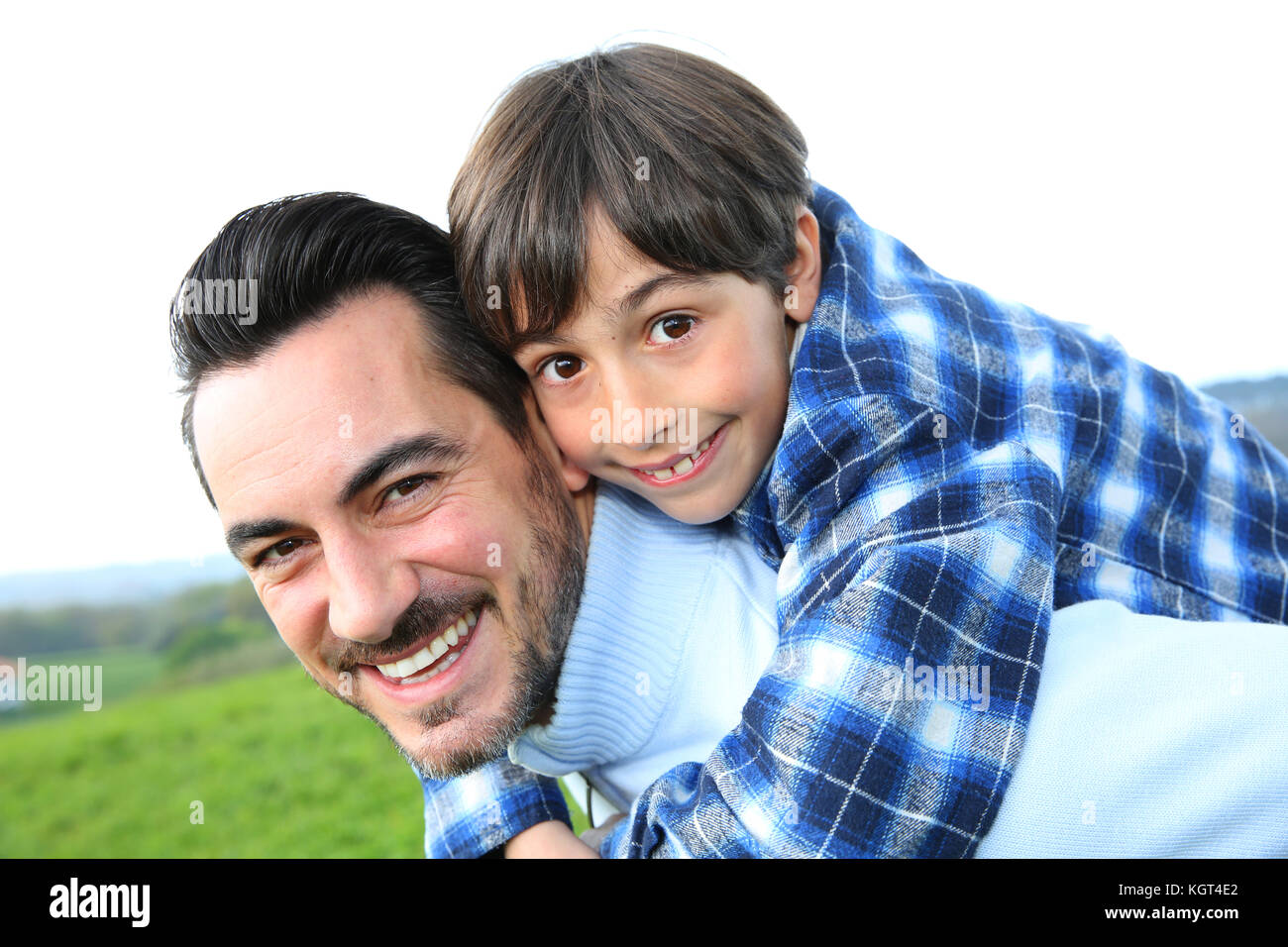 Man holding son on her back Stock Photo - Alamy