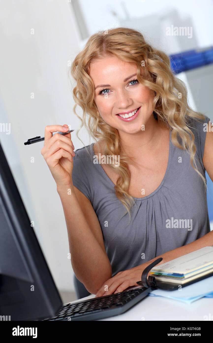 Beautiful woman in office working on desktop computer Stock Photo - Alamy