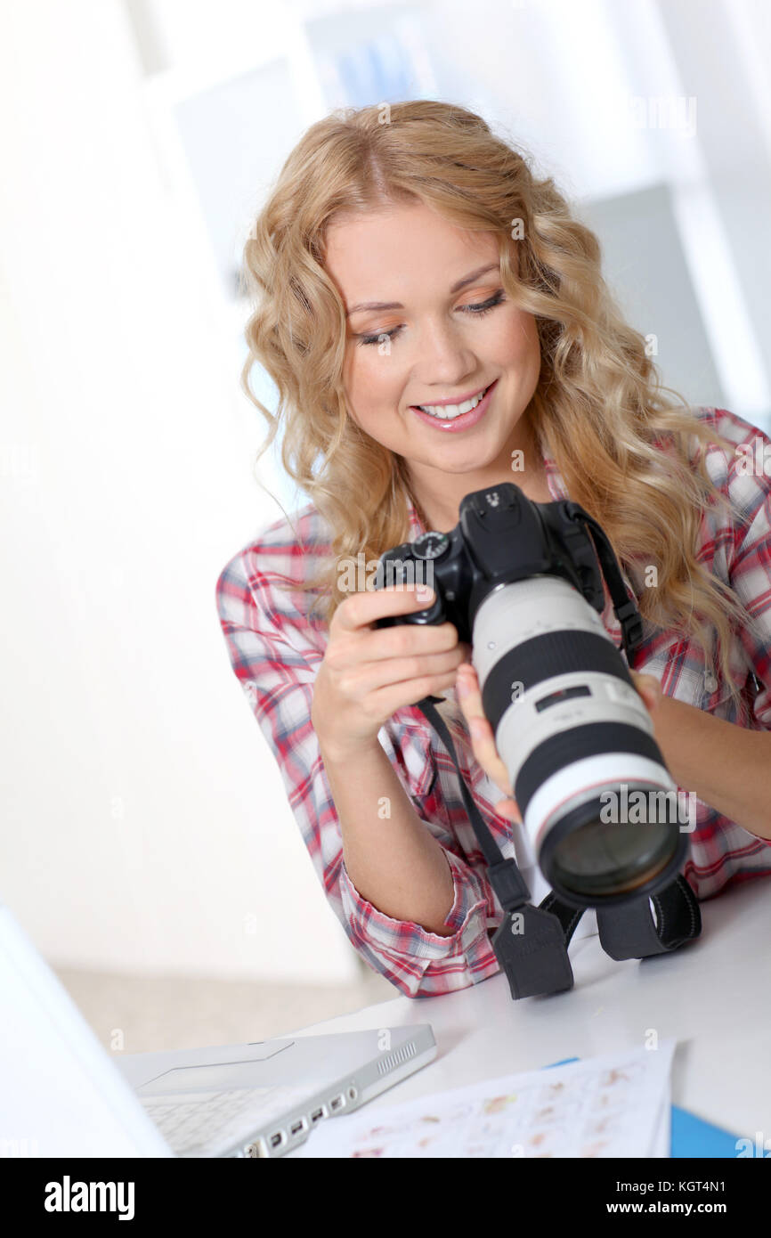 Photographer looking at photo camera Stock Photo - Alamy