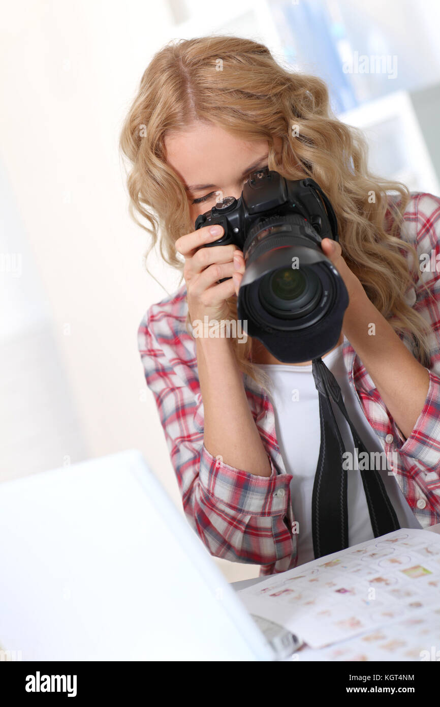 Photographer looking at photo camera Stock Photo - Alamy