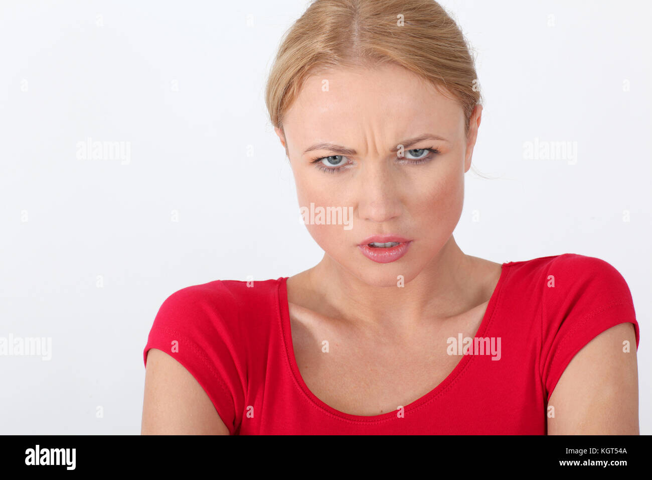 Woman in red shirt with angry look Stock Photo - Alamy