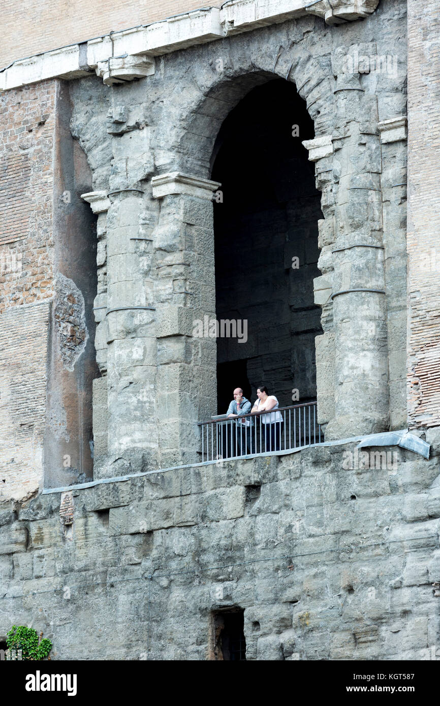 couple leaning on railings framed by Roman archway Stock Photo - Alamy