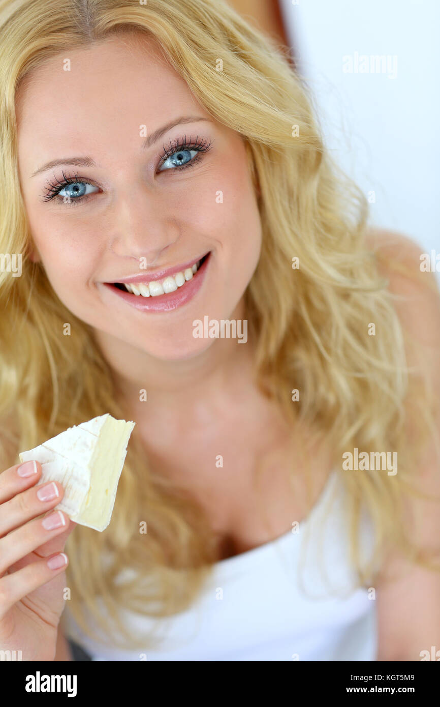 Attractive girl holding slice of french cheese Stock Photo - Alamy