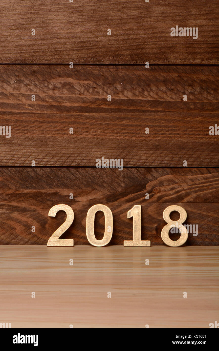 New year two thousand and eighteen in golden wood letters on wooden ...