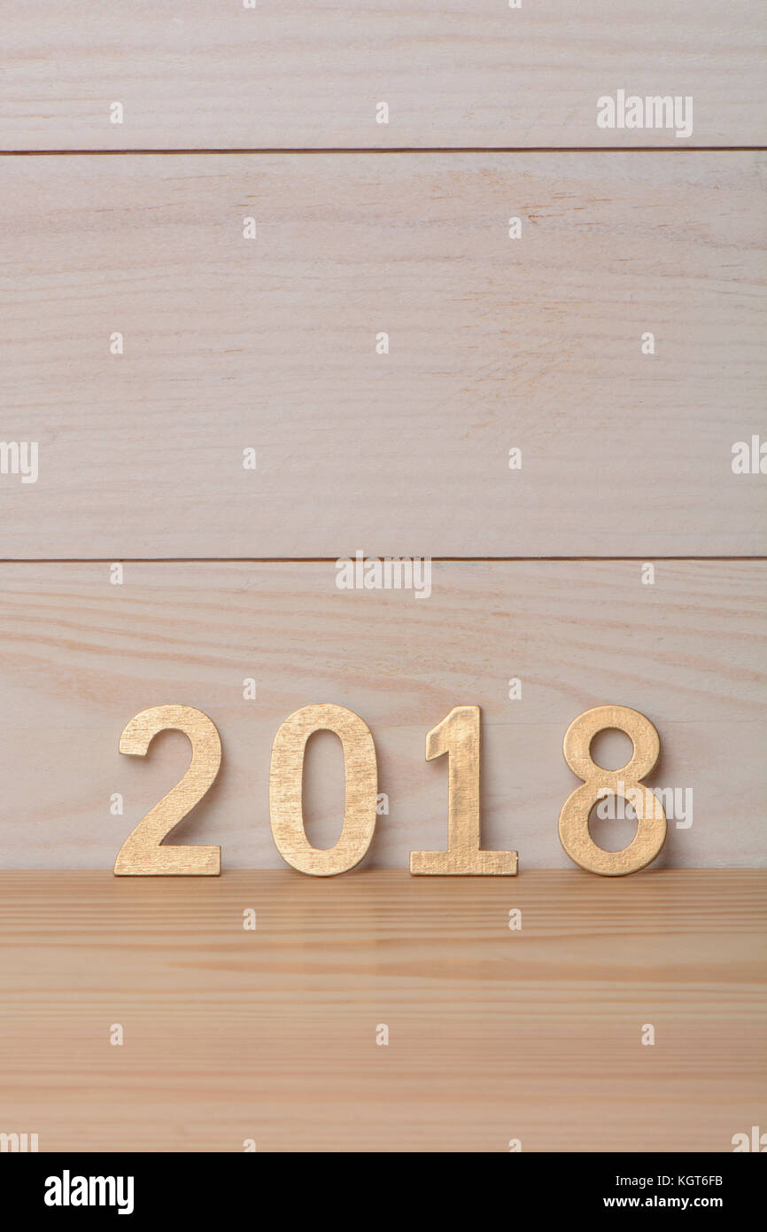 New year two thousand and eighteen in golden wood letters on wooden ...
